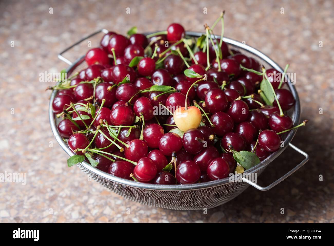 Cherries in a steel sieve. top view, texture Stock Photo - Alamy