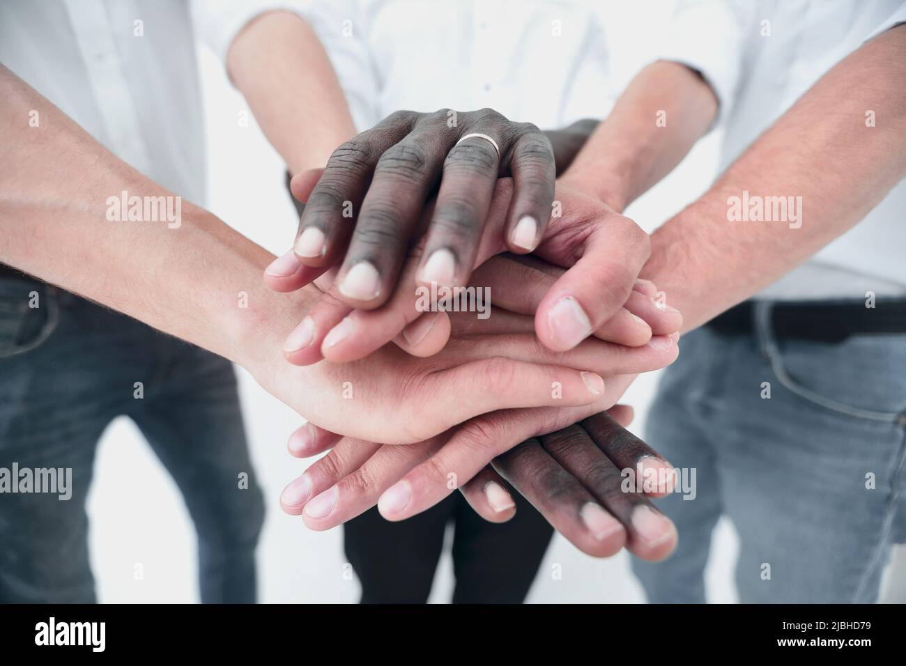 Business team joining hands together Stock Photo - Alamy