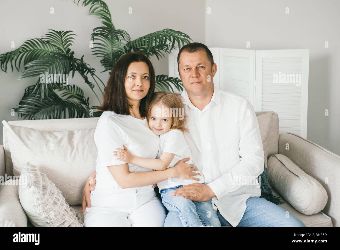 Happy family of three at home Stock Photo - Alamy