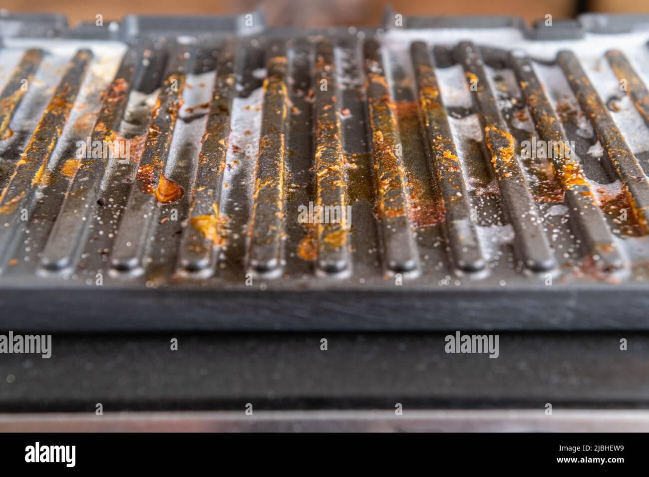 Dirty electric grill. Fat spots on a frying pan. Drops of fat Stock ...