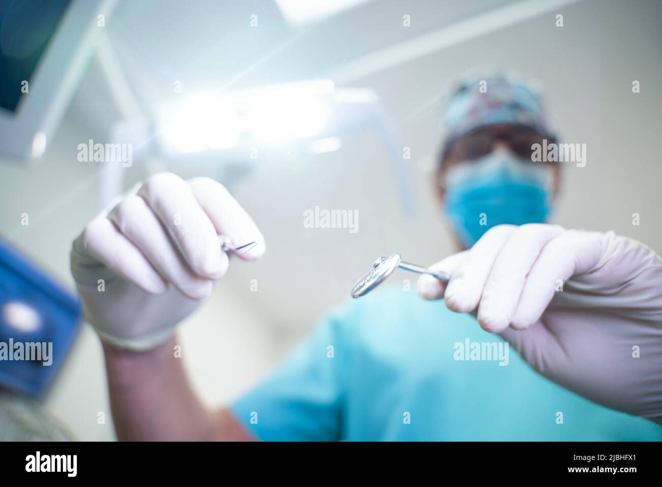 Dentist handling dental tools in patient's view Stock Photo - Alamy