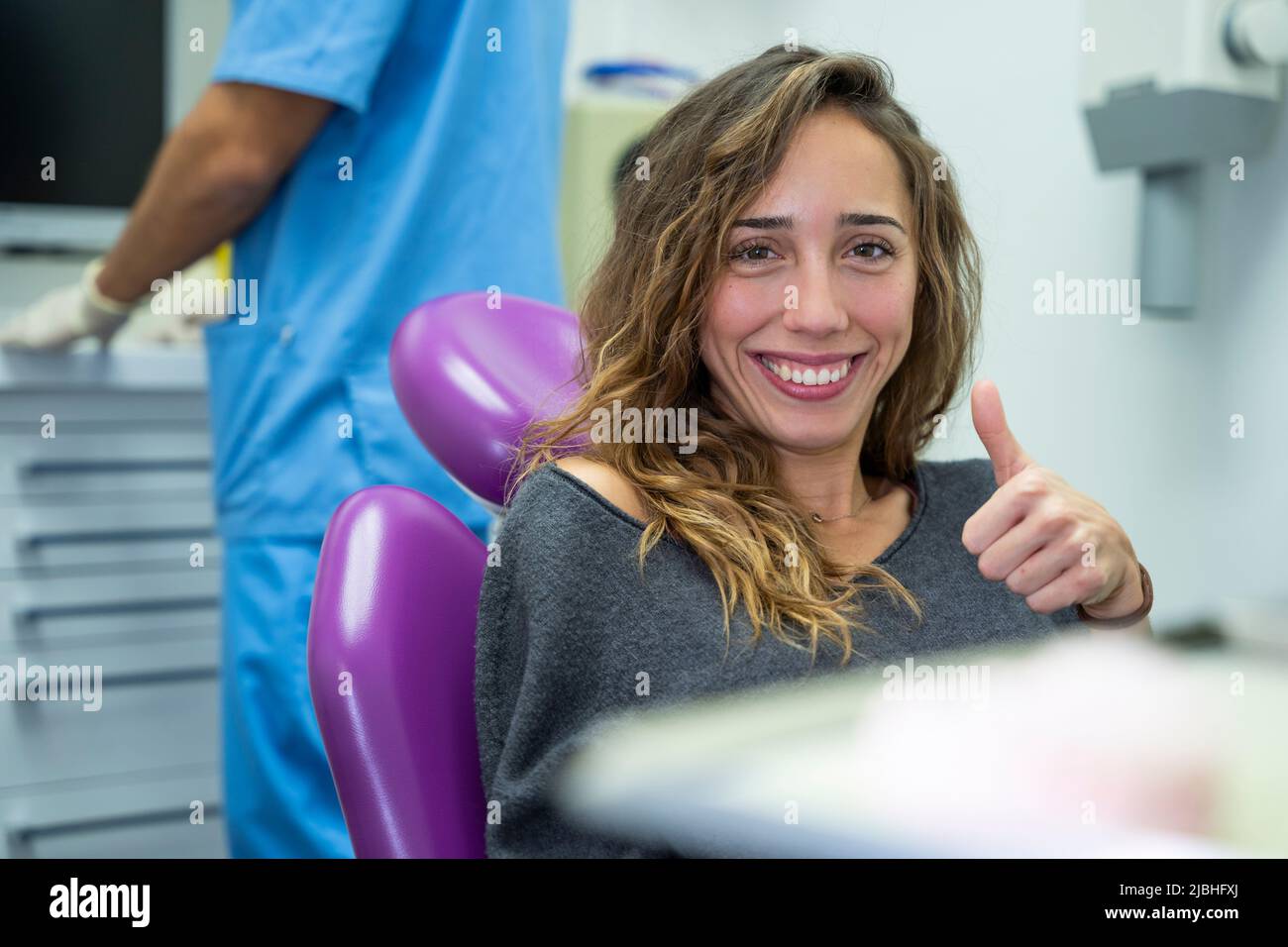 Female patient smiling in the dental clinic Stock Photo - Alamy