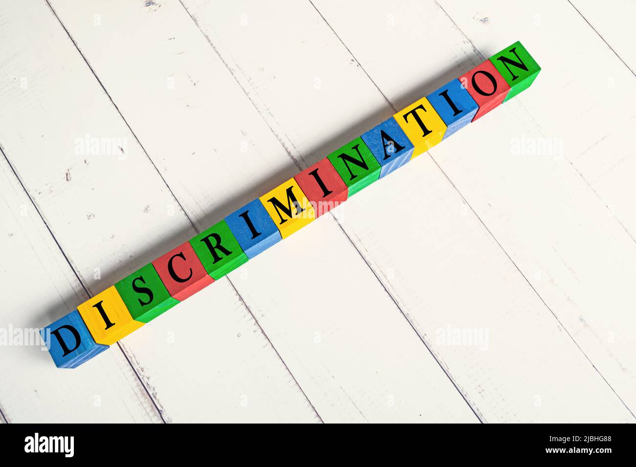 Discrimination word on colorful wooden block cube. Prejudicial ...