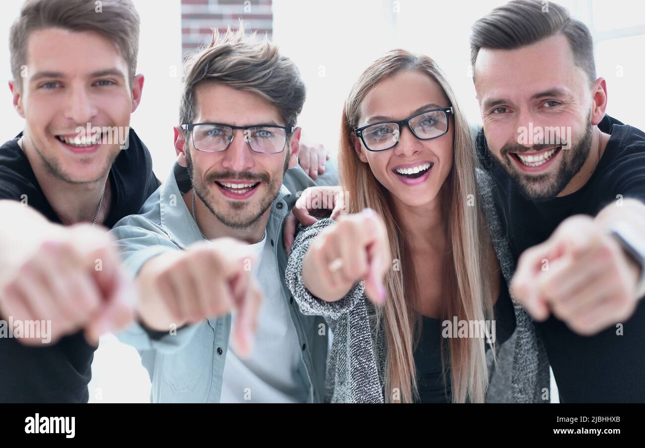 a group of students is happy to pass the session and point a finger at ...