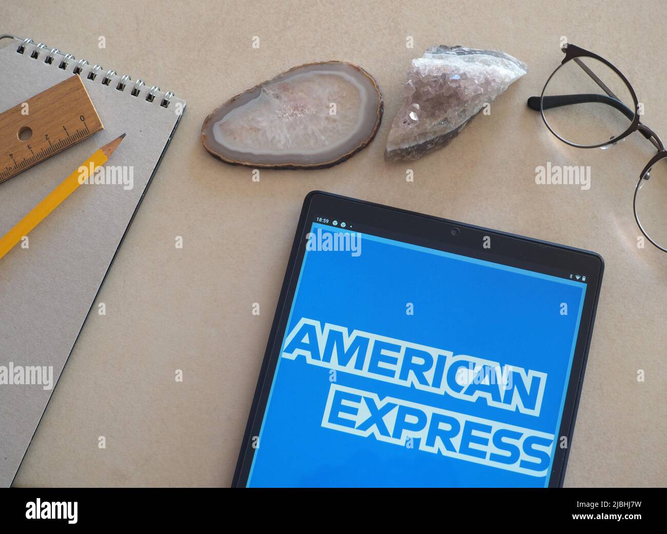 In this photo illustration American Express Company logo seen displayed ...