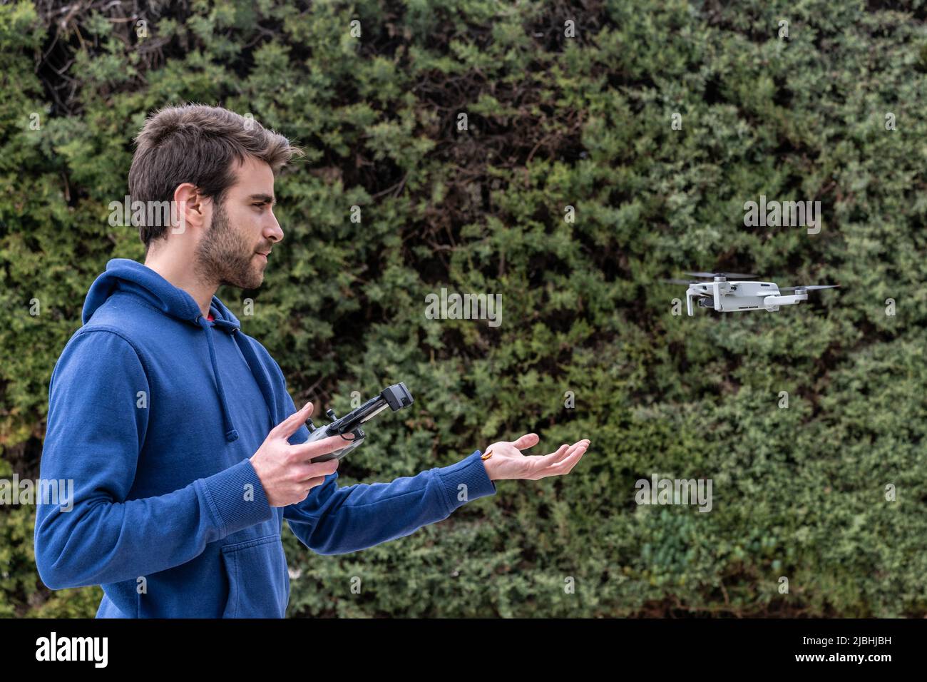 Young man taking off a flying drone outdoors in the park Stock Photo ...