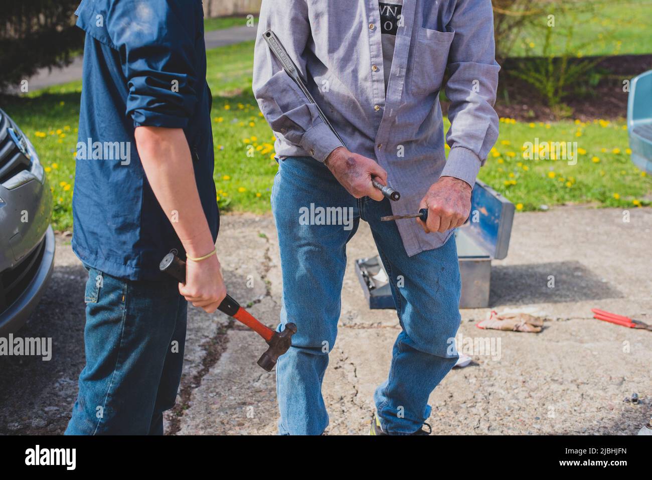 A young man and an older man with tools working together Stock Photo ...