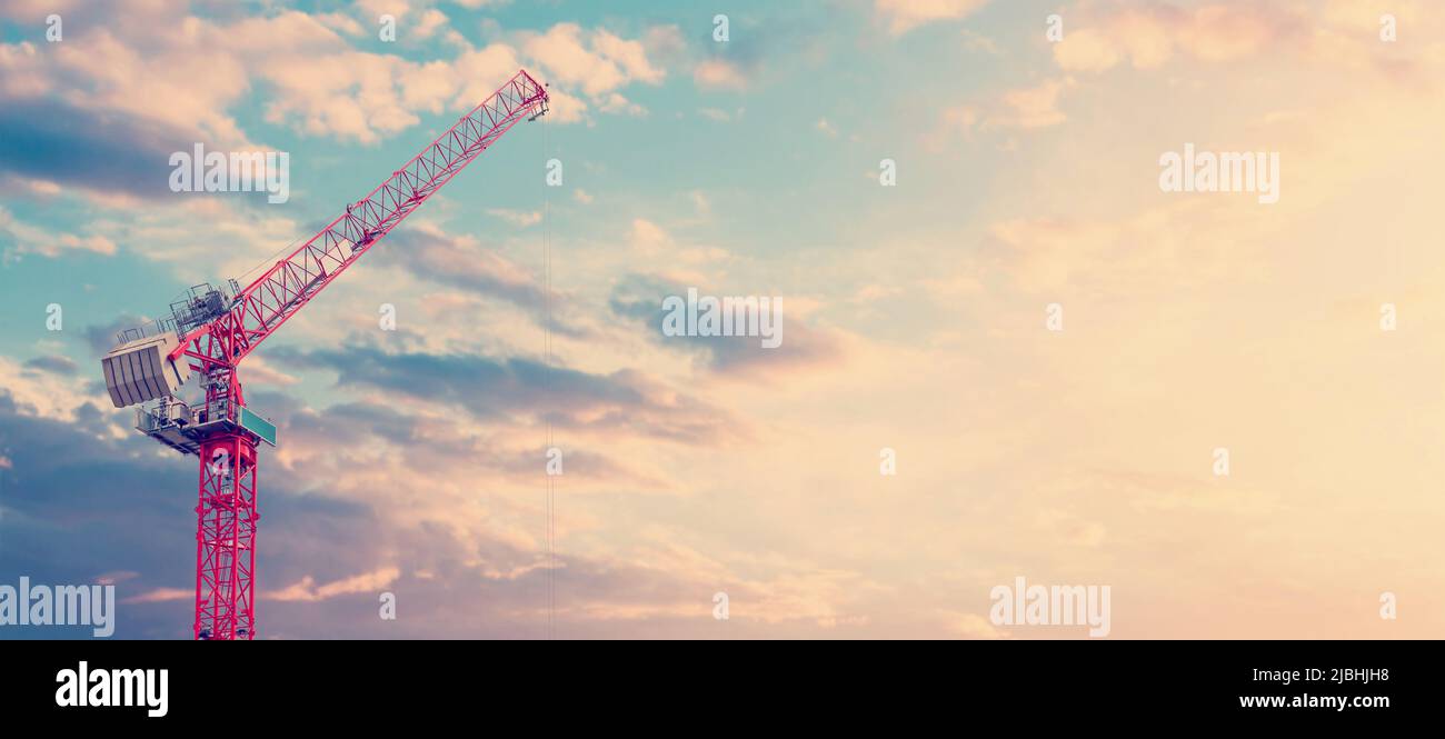 Tower crane on a dramatic sky background Stock Photo - Alamy
