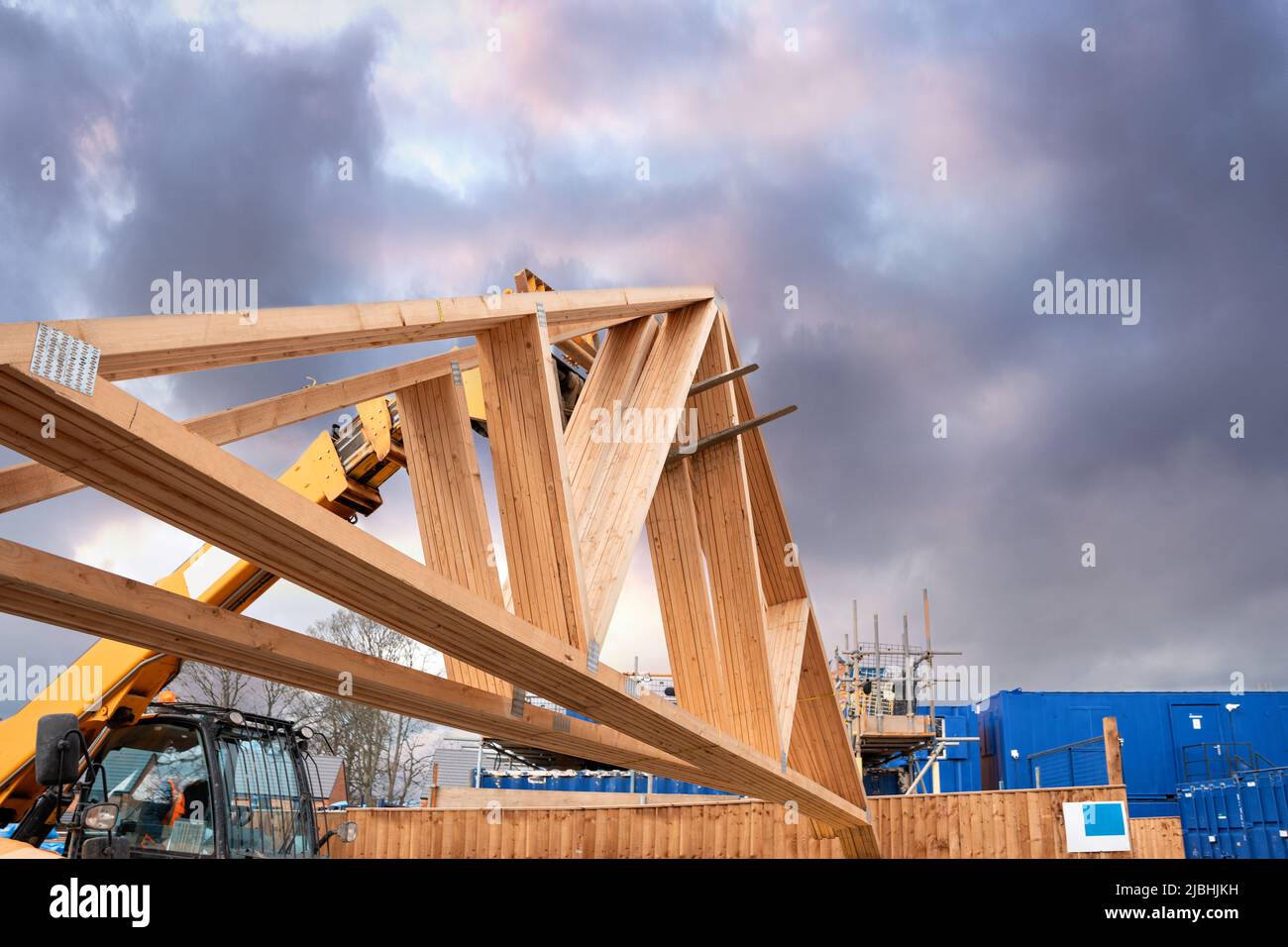 Heavy machinery shifting roof trusses on new residential housing ...