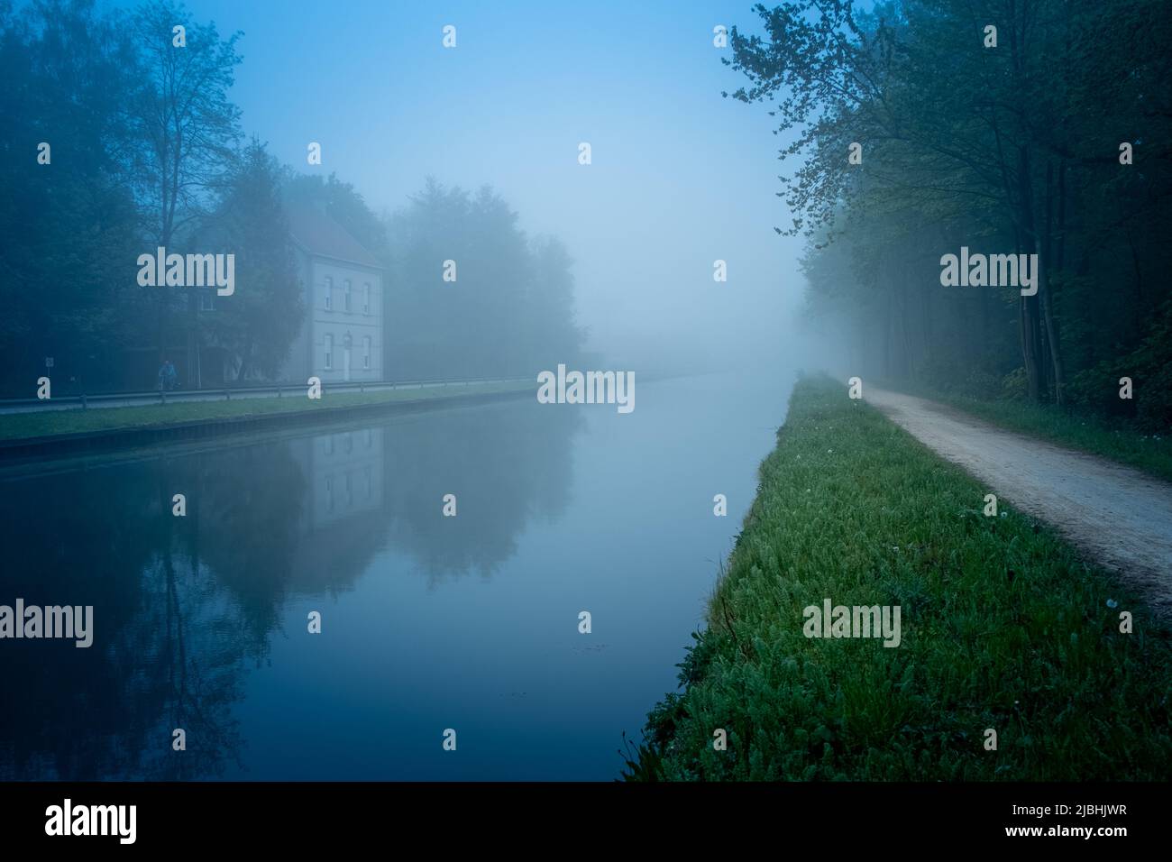 Beautiful spring sunrise over river banks. Morning fog in the forest ...