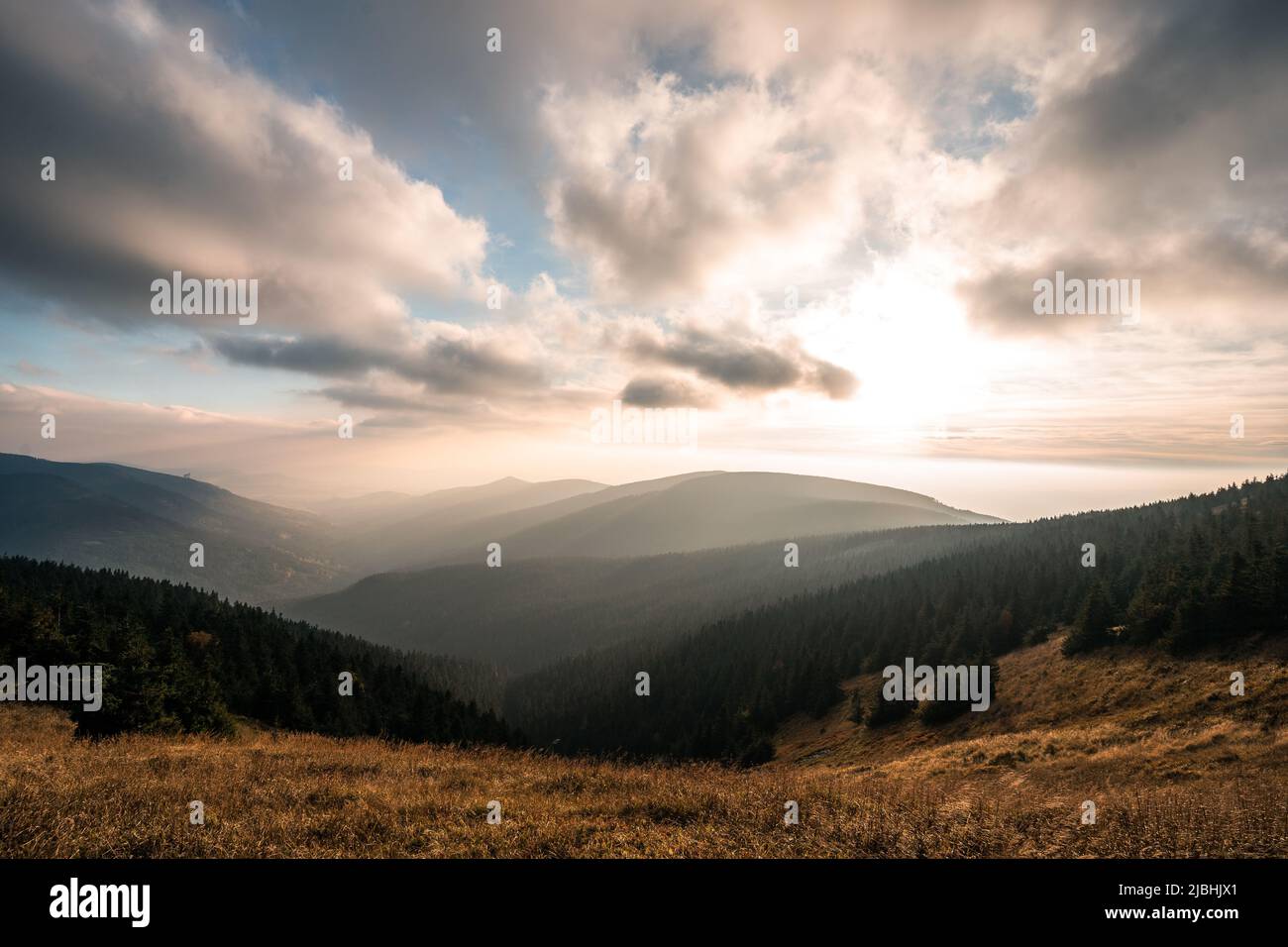 Landscape of warm light sun rays on sky through the clouds over the ...