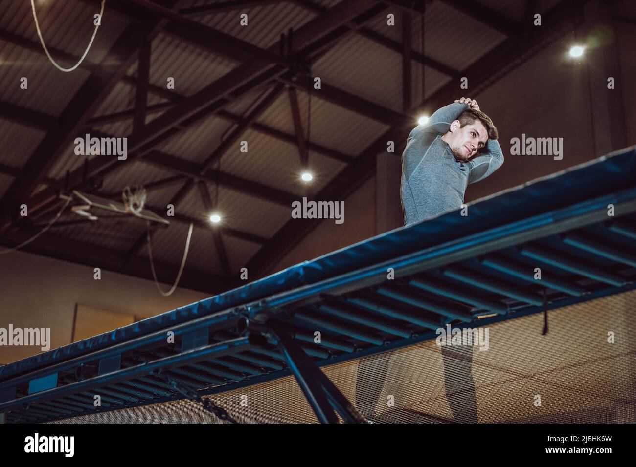 Young acrobat man do warm-up exercises before the training Stock Photo ...