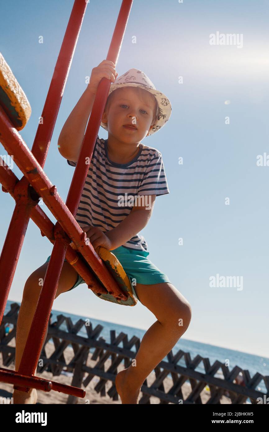 Child swinging at the beach hi-res stock photography and images - Alamy