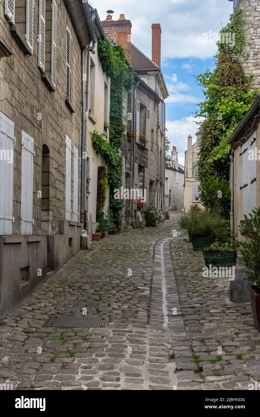 Senlis, medieval city in France, typical street with ancient houses ...