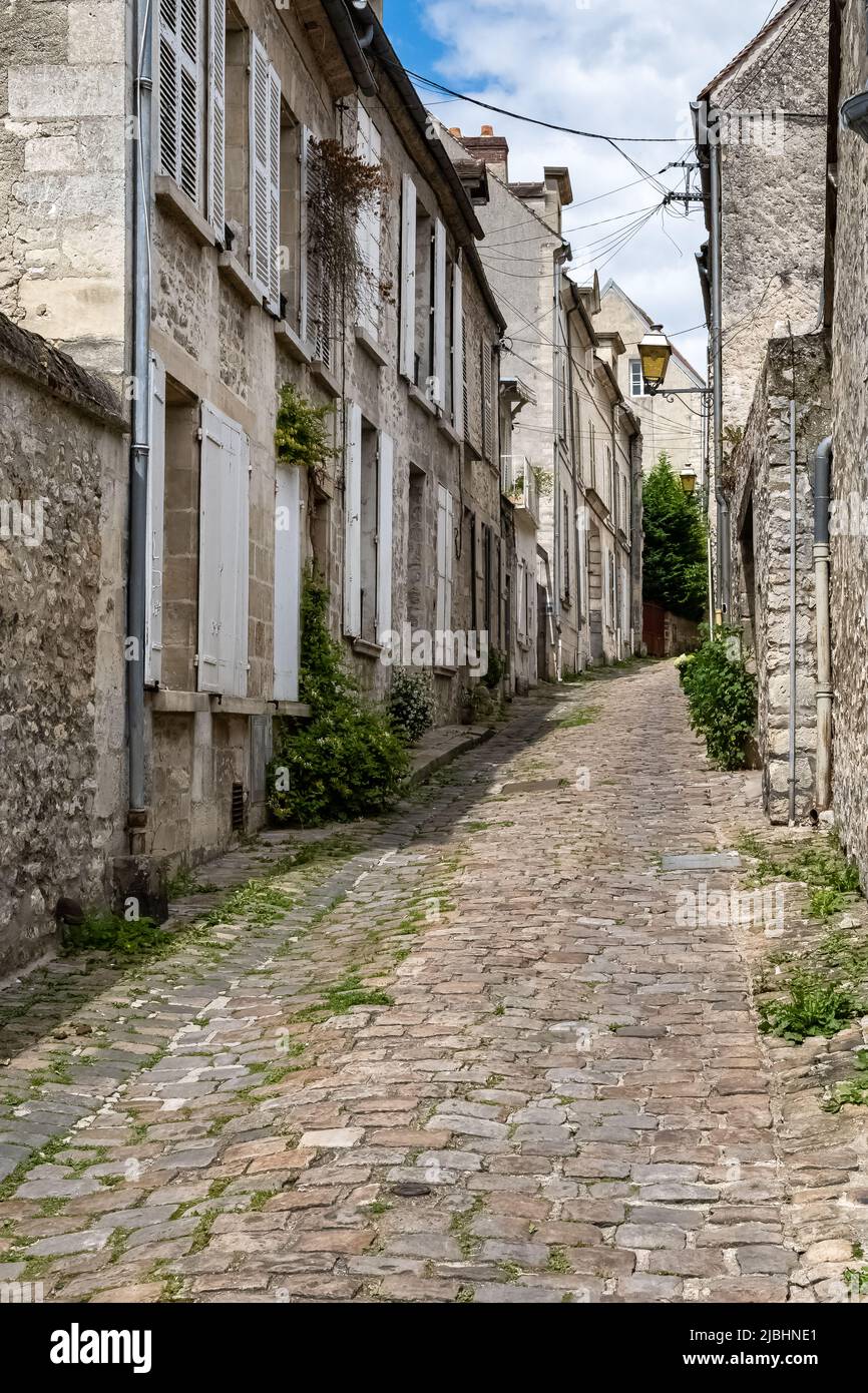Senlis, medieval city in France, typical street with ancient houses ...