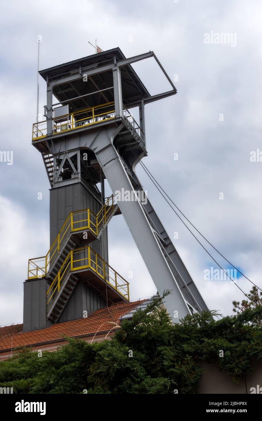 View of the mine shaft elevator wheels against the cloudy sky. The ...