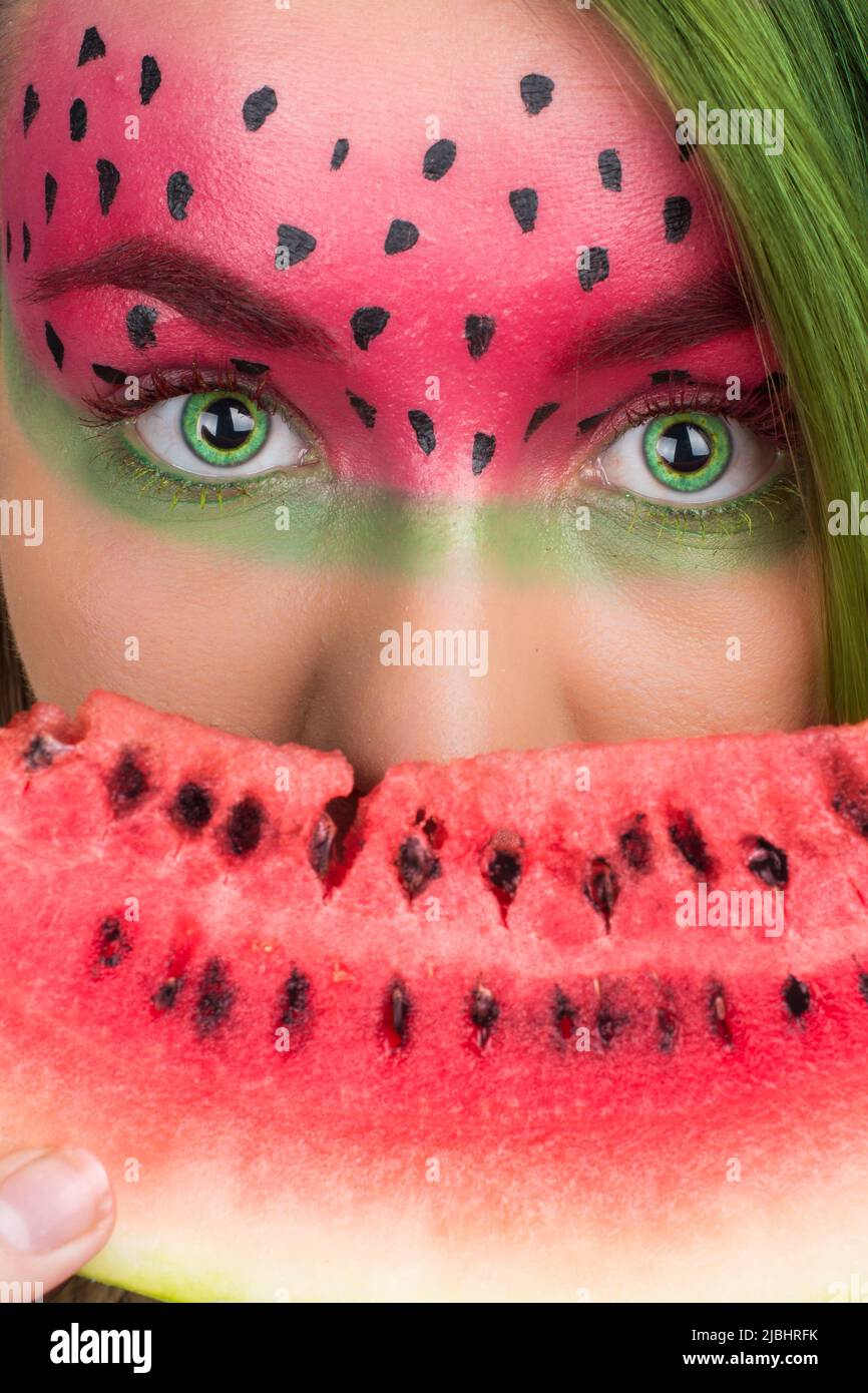 Fantasy watermelon makeup portrait of a woman with a watermelon slice ...