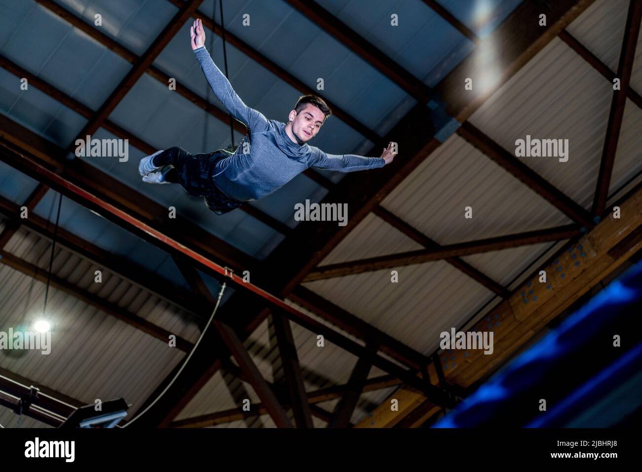 Caucasian man jumping concentrated in trampoline Stock Photo - Alamy