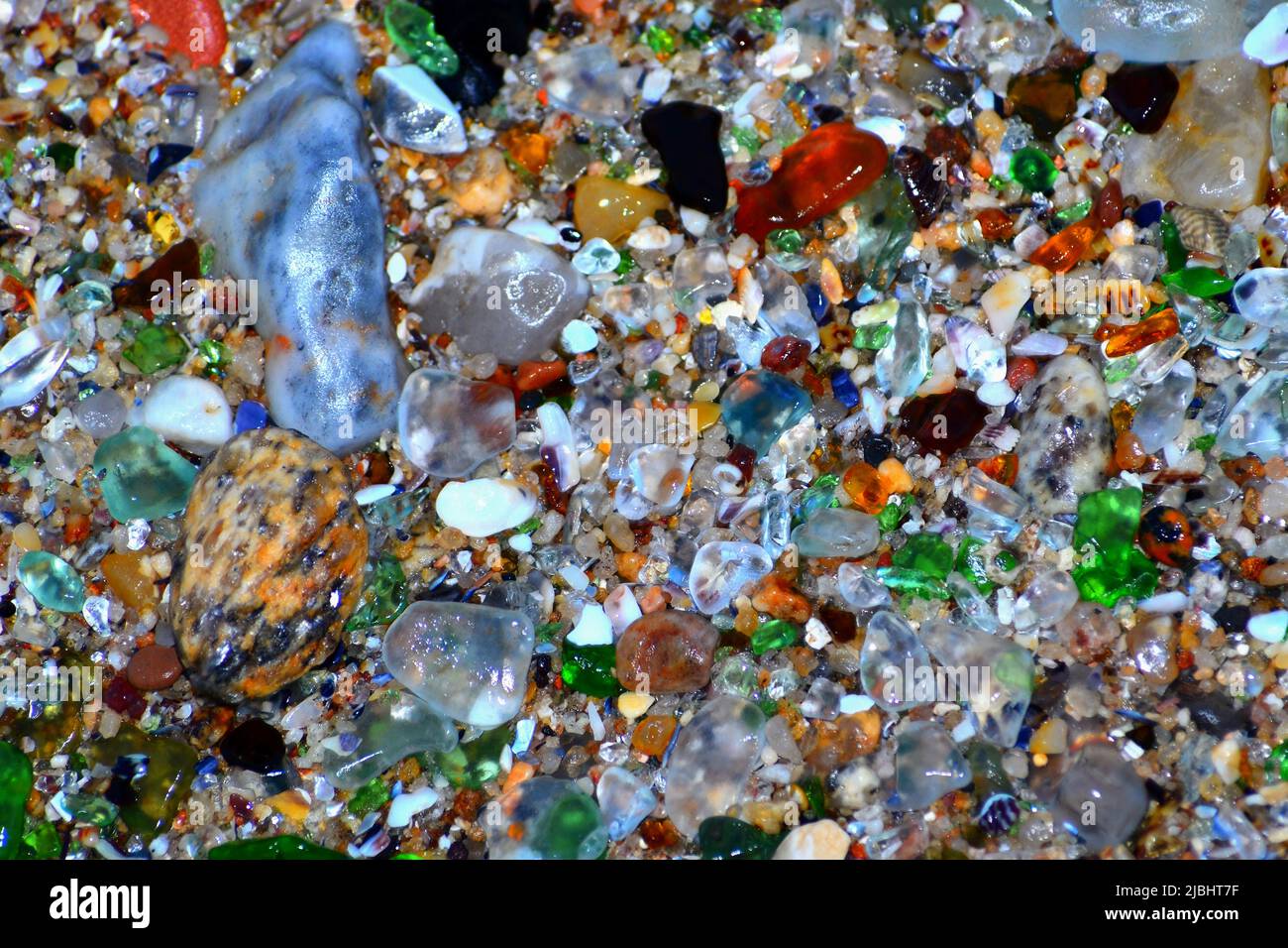 Seabed with coloured stones and glass Stock Photo - Alamy