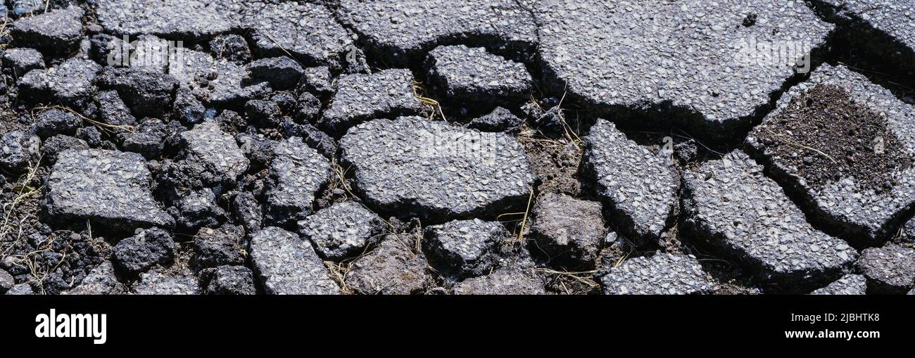 Panoramic view of an abstract cracked and crumbling asphalt road ...