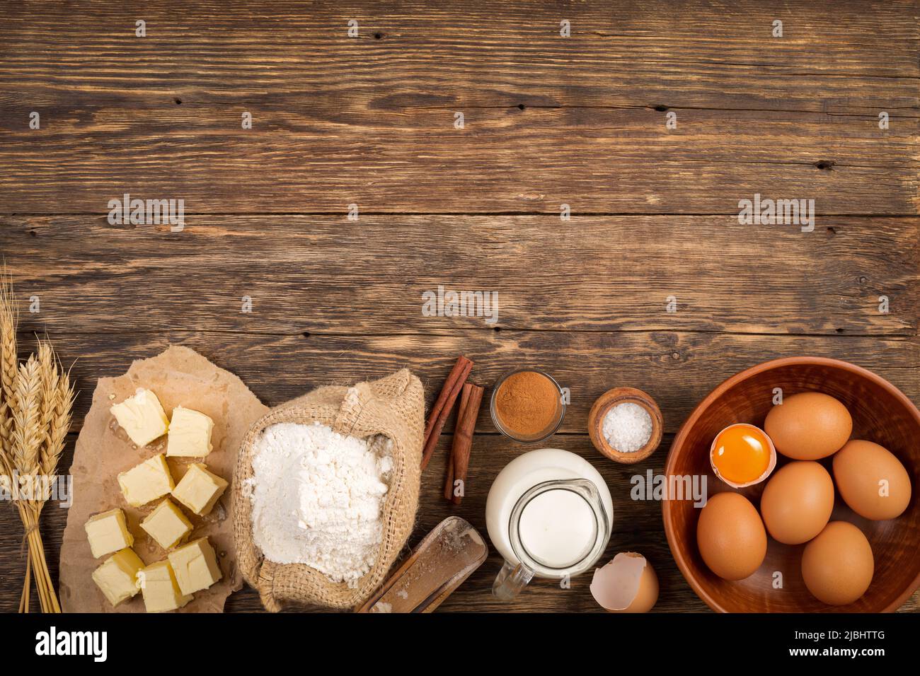 Ingredients for baking bread and muffins on a wooden table with copy ...