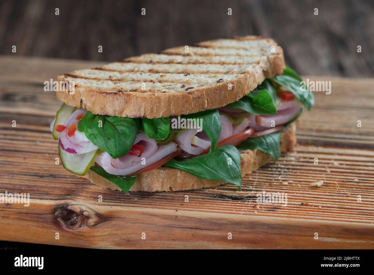 Preparing a traditional American sandwich with ham and herbs. Home ...