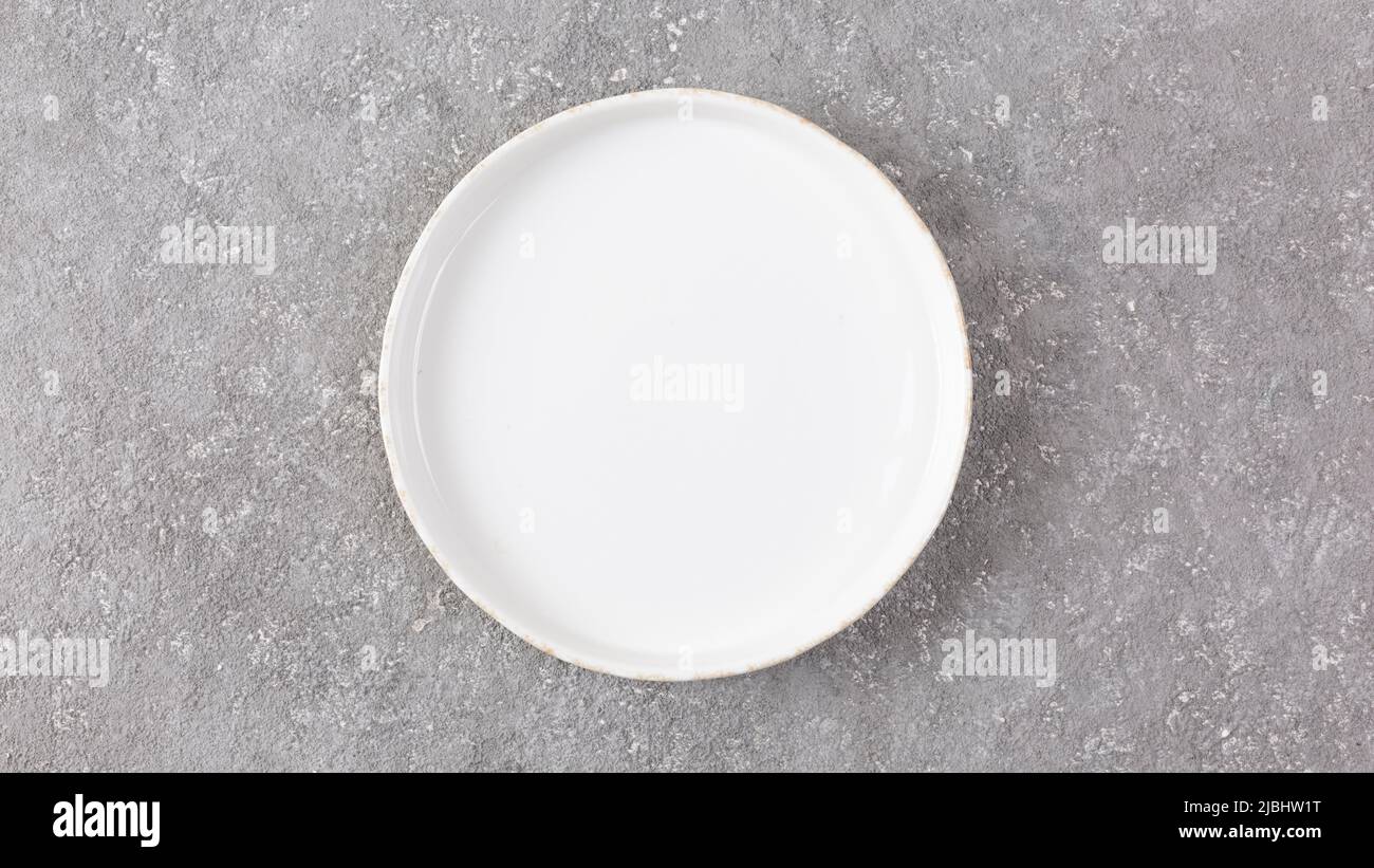 Empty white plate on gray concrete background, menu concept Stock Photo ...