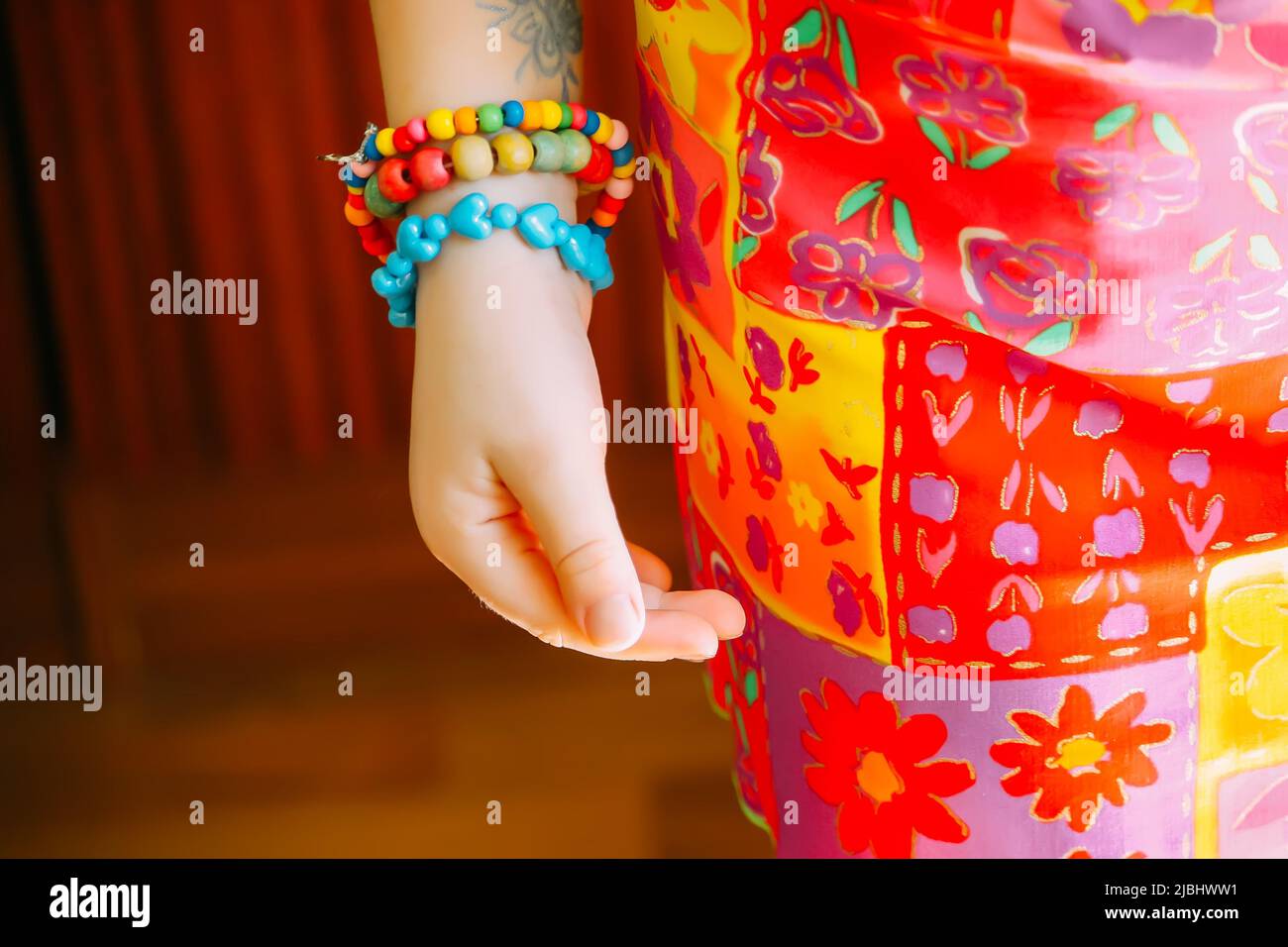 Handmade bright beads on a child's body in sunlight Stock Photo - Alamy
