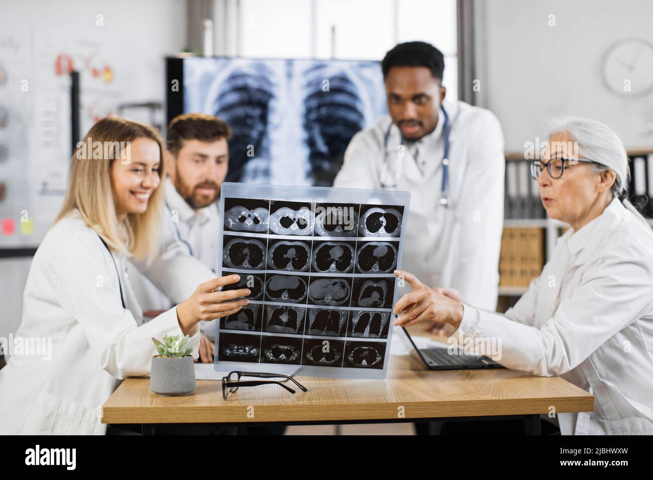 Multiracial male and female doctors having briefing at clinic for ...