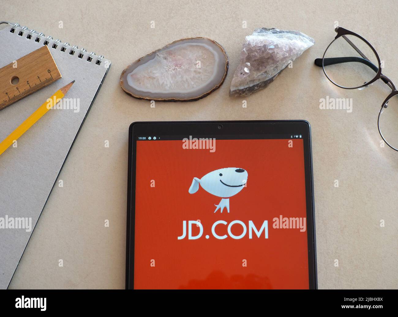 In this photo illustration JD.com, Inc. logo seen displayed on a tablet ...