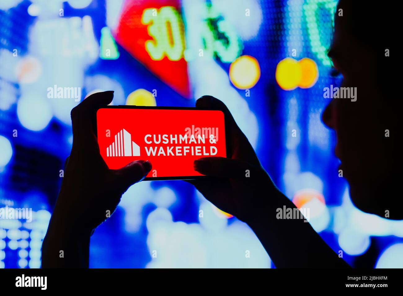 In this photo illustration, a silhouetted woman holds a smartphone with ...