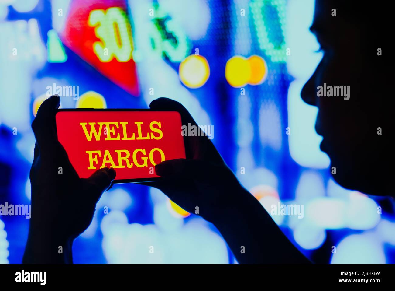 In this photo illustration, a silhouetted woman holds a smartphone with ...