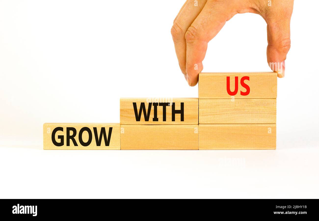 Grow with us symbol. Concept words Grow with us on wooden blocks on a beautiful white table ...
