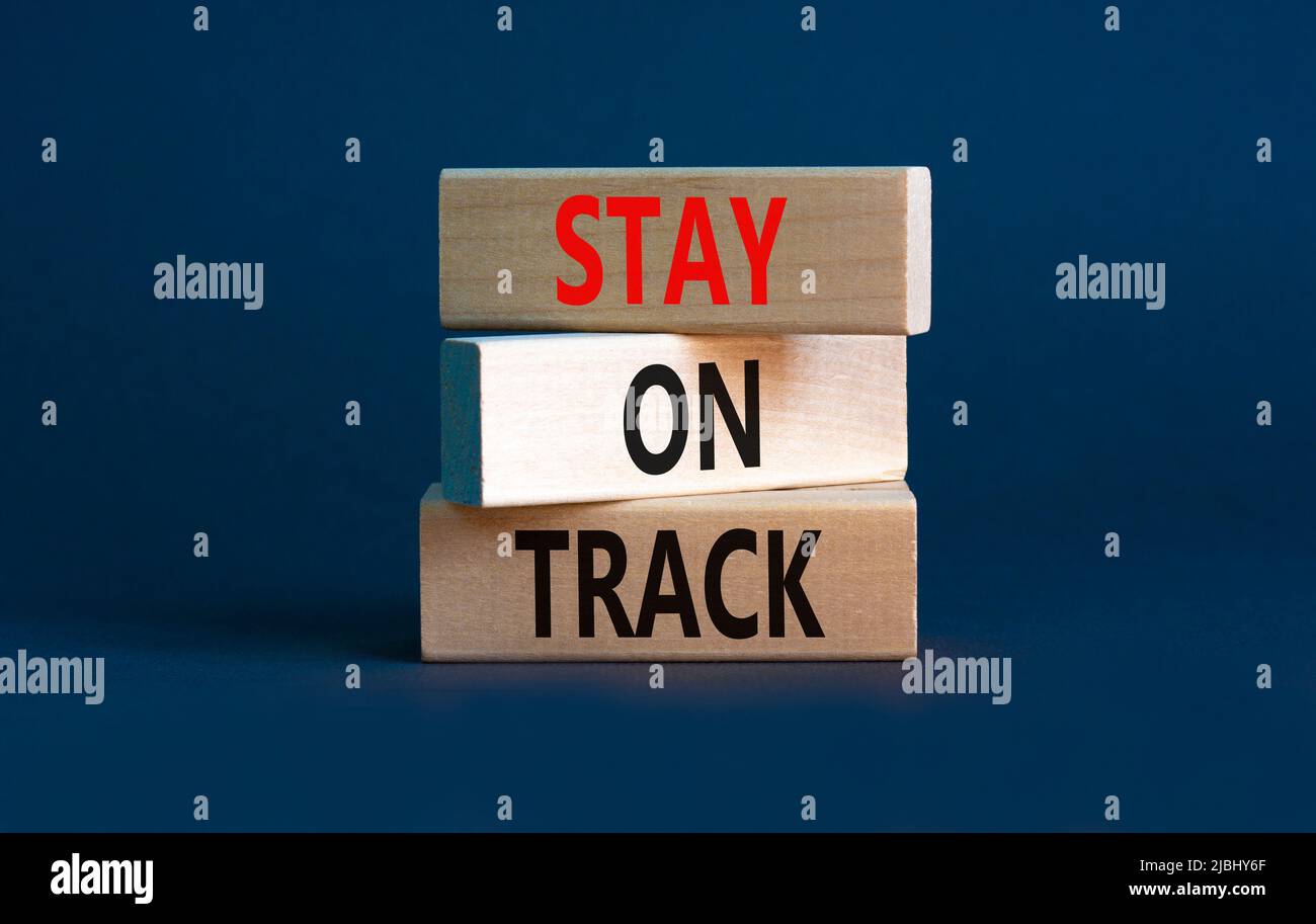 Stay on track symbol. Concept words Stay on track on wooden blocks on a ...