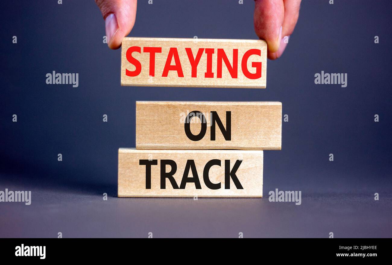Staying on track symbol. Concept words Staying on track on wooden ...