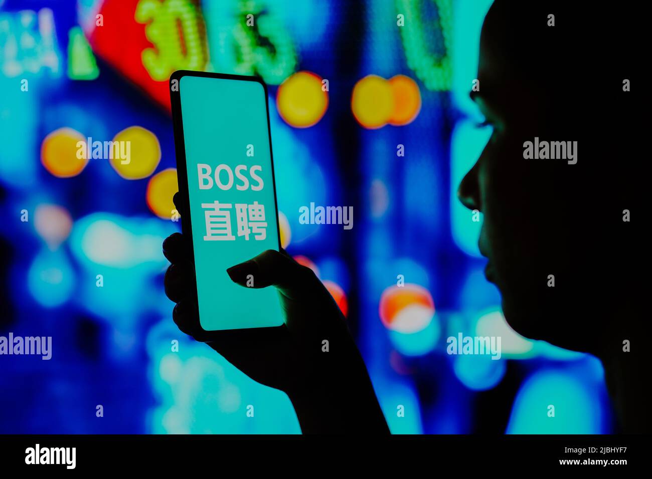 In this photo illustration, a silhouetted woman holds a smartphone with ...