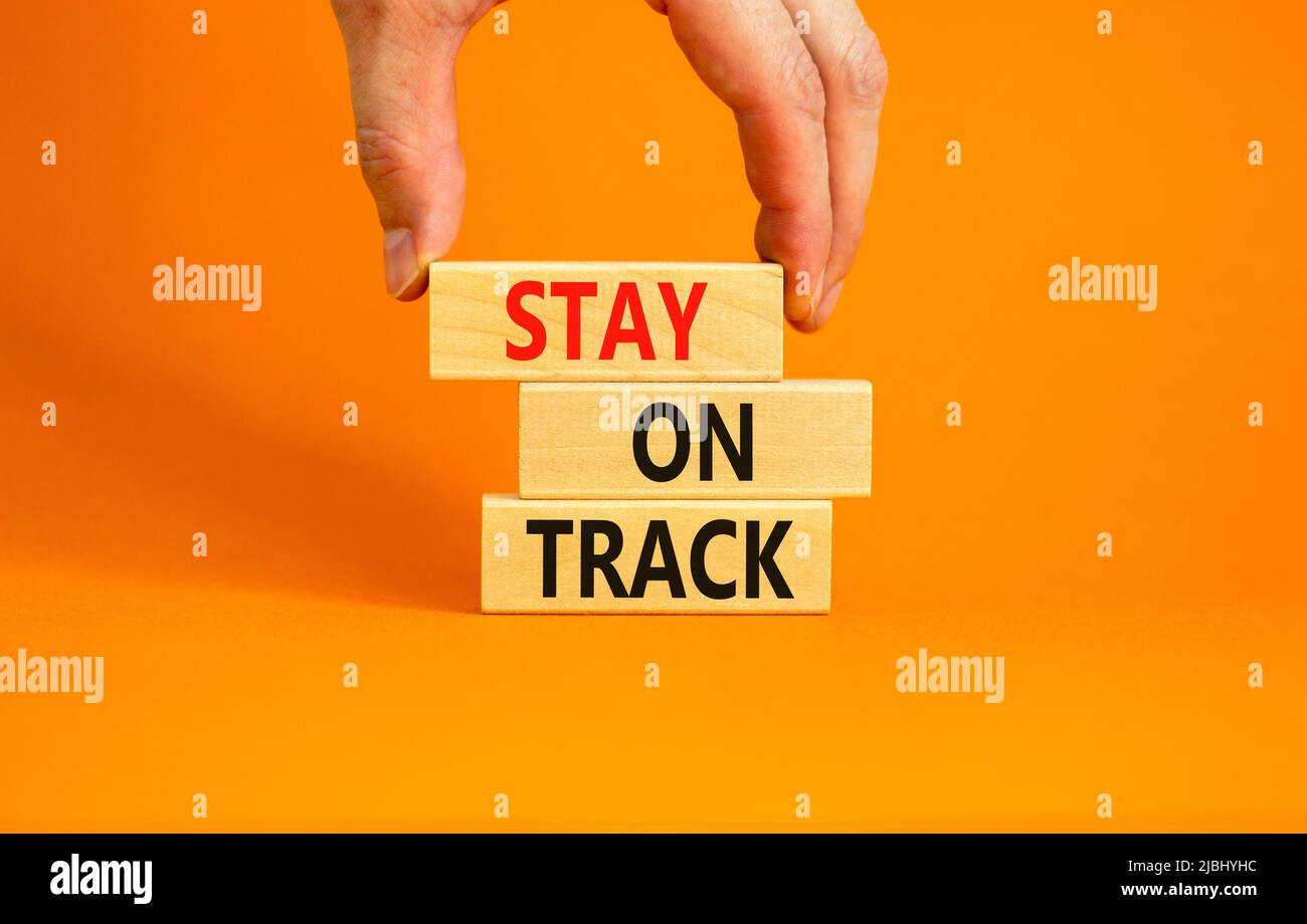 Stay on track symbol. Concept words Stay on track on wooden blocks on a ...