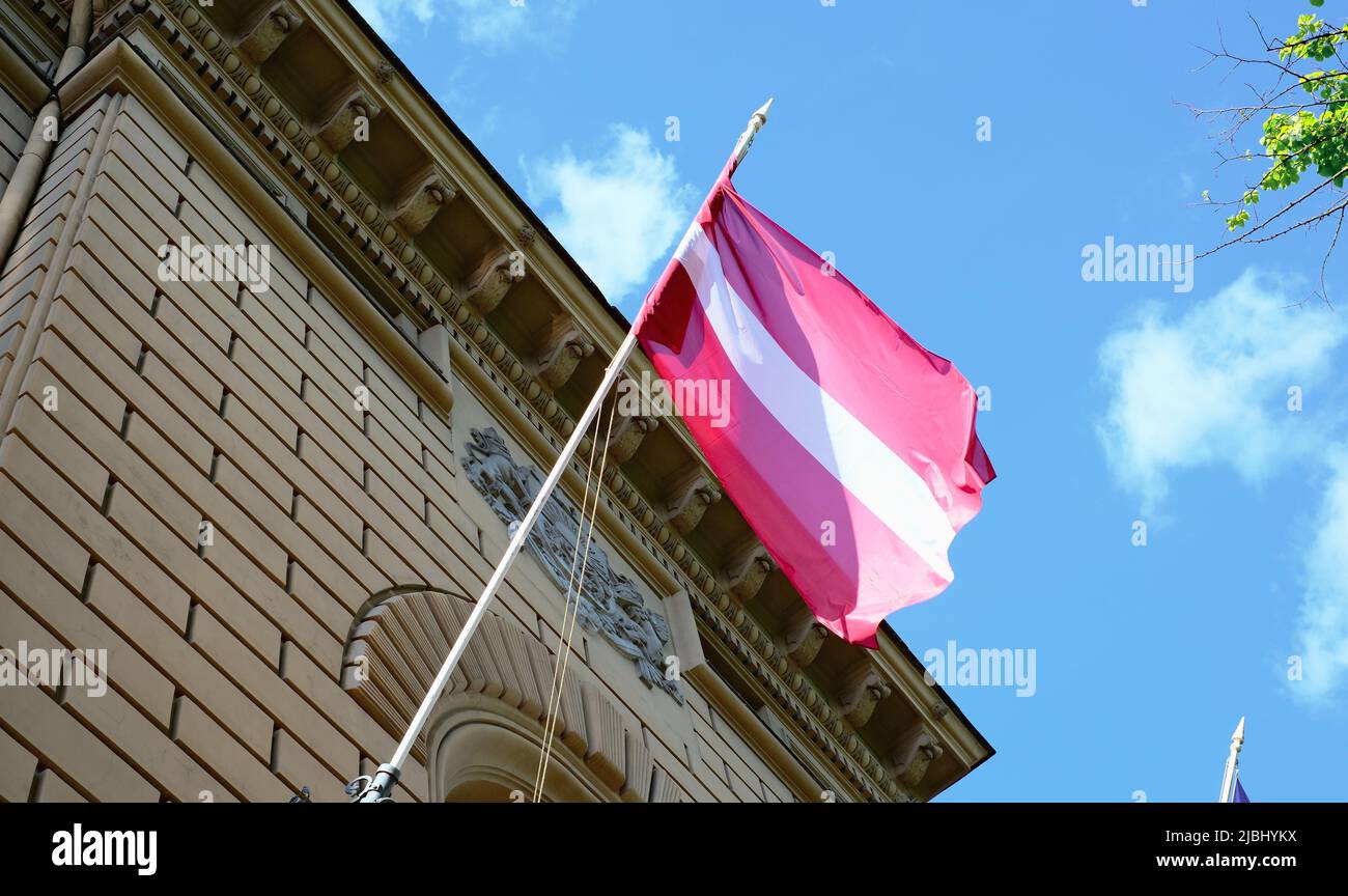 The official state symbol of Latvia is a flag with a two red and ...