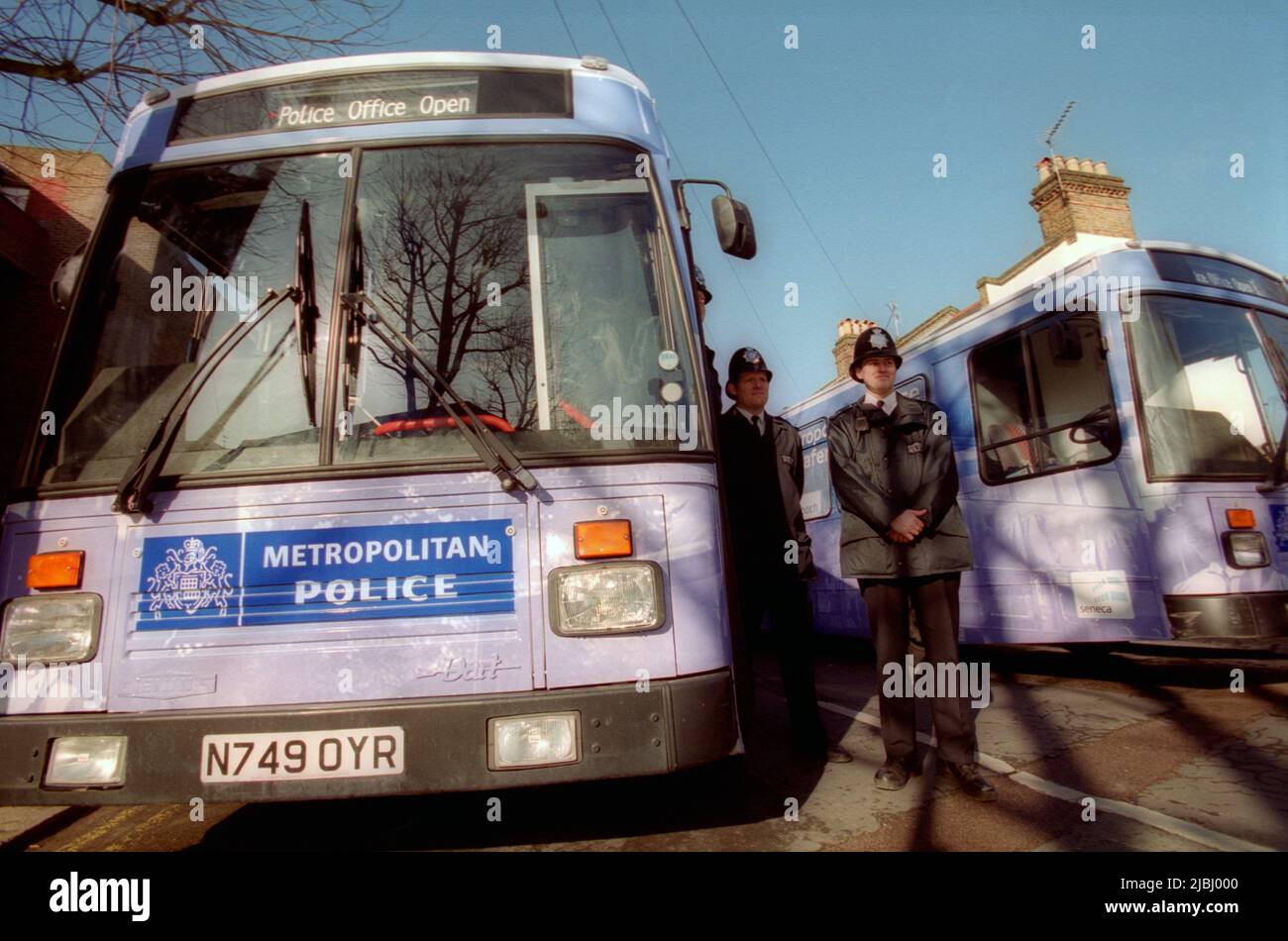 Mobile London Met Police bus with police officers standing to attention ...