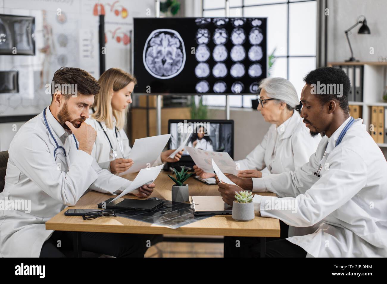 Multicultural group of four medical researchers having online training ...