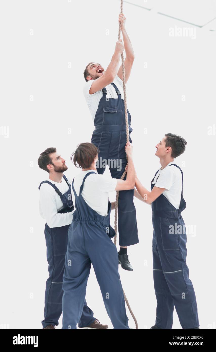 view from the top. team work in helping the leader to climb up Stock ...