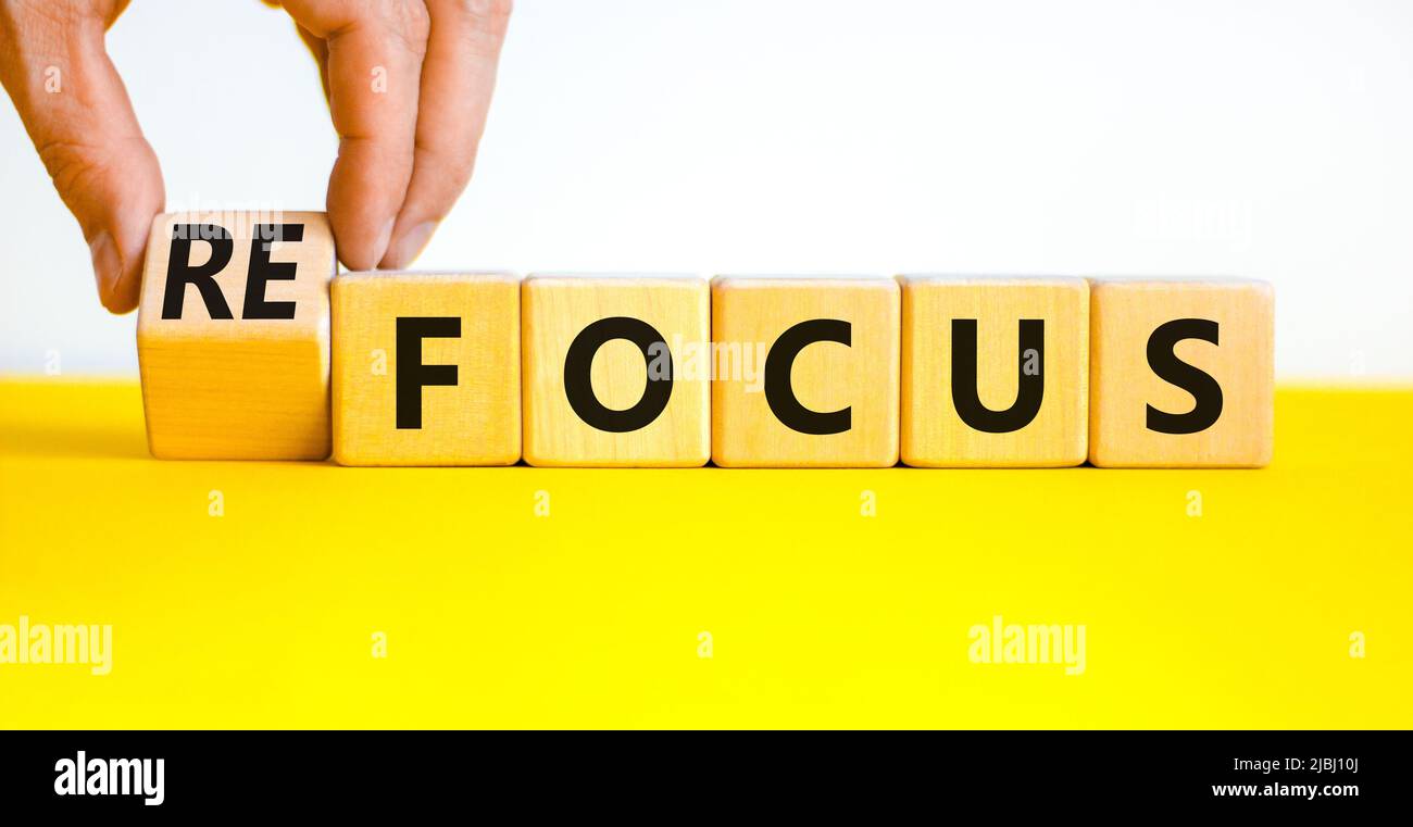 Focus or refocus symbol. Businessman turns wooden cubes and changes the ...