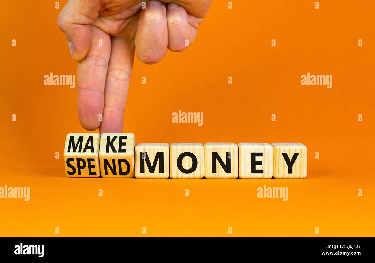 Spend or make money symbol. Businessman turns cubes and changes concept ...
