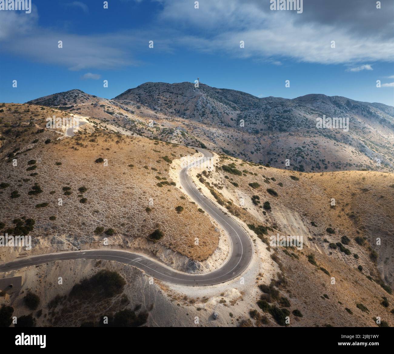 Aerial view of winding mountain road, blue sky at sunrise Stock Photo ...