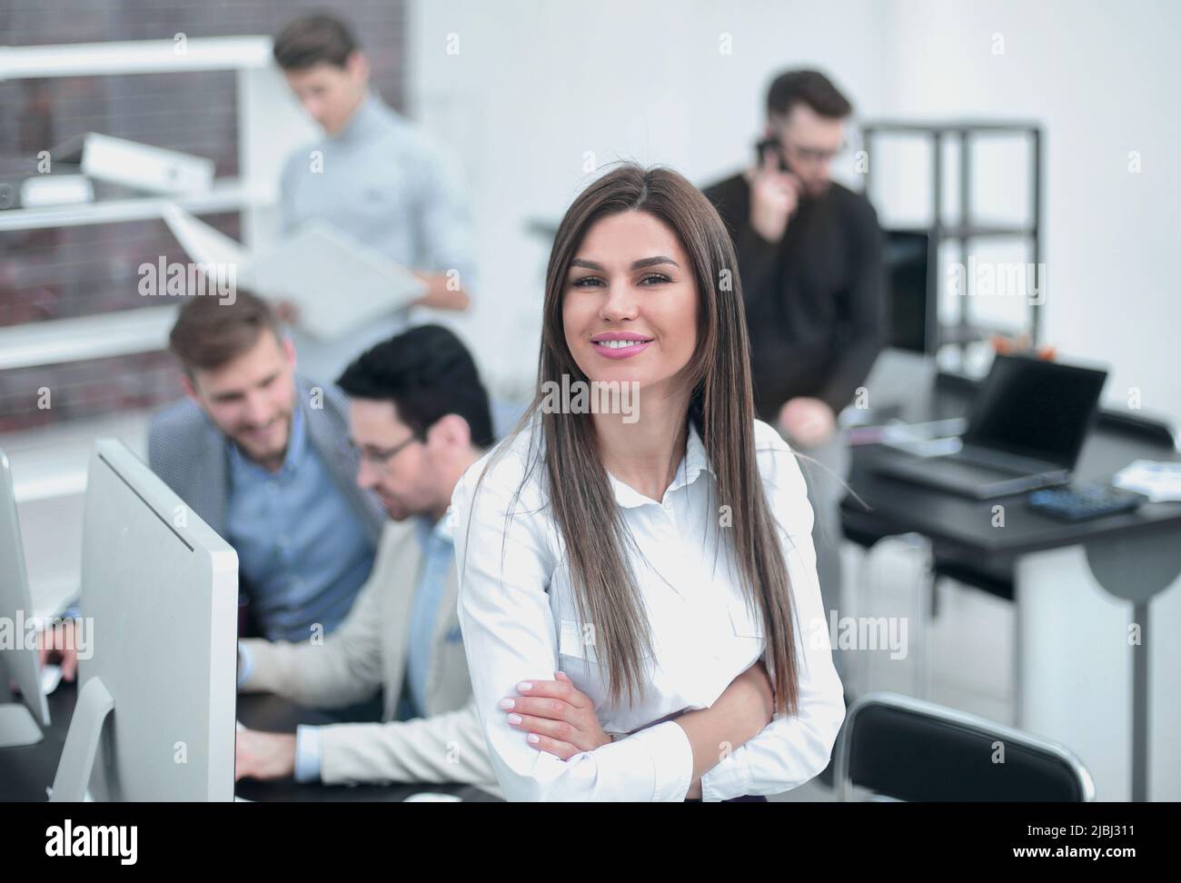 young employee on the background of the office Stock Photo - Alamy