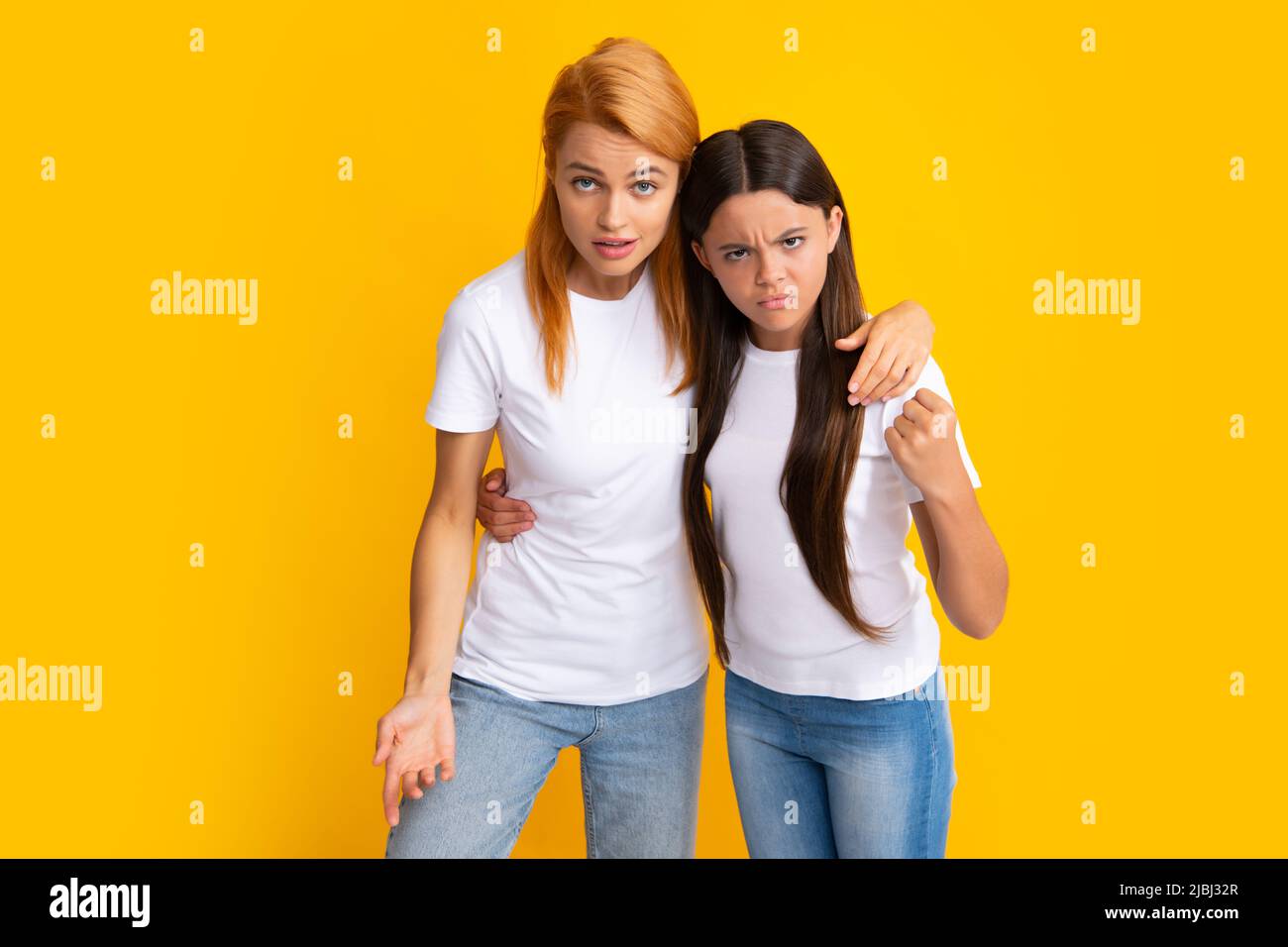 Woman with child teen girl. Mommy and daughter isolated on yellow ...