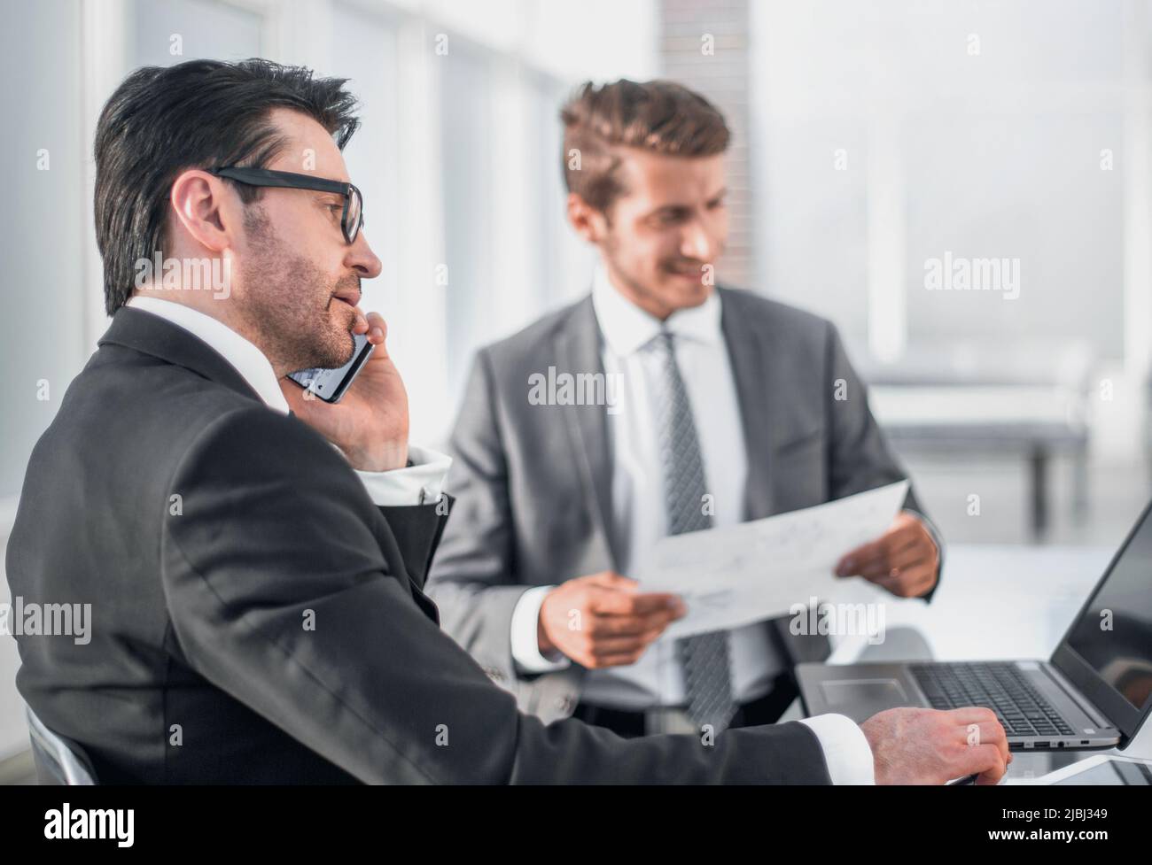 employees use a laptop to check new data Stock Photo - Alamy