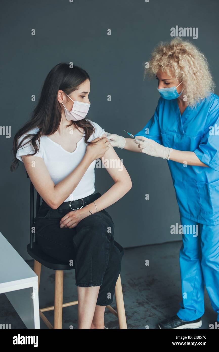Patient receiving Covid-19 vaccine injection during doctor's ...