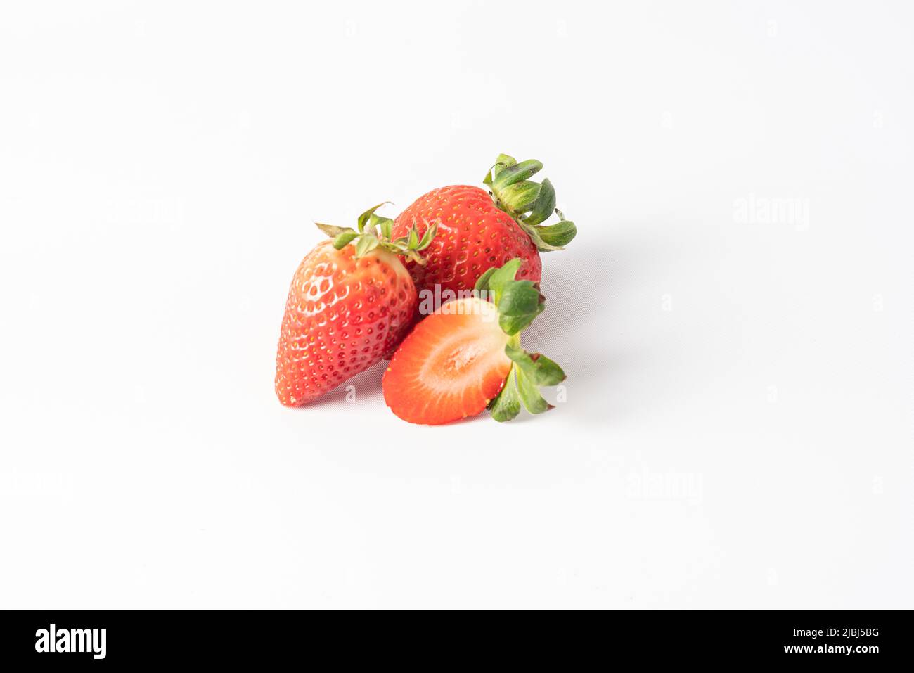 Strawberry fruit cut in half slice isolated on white background Stock ...