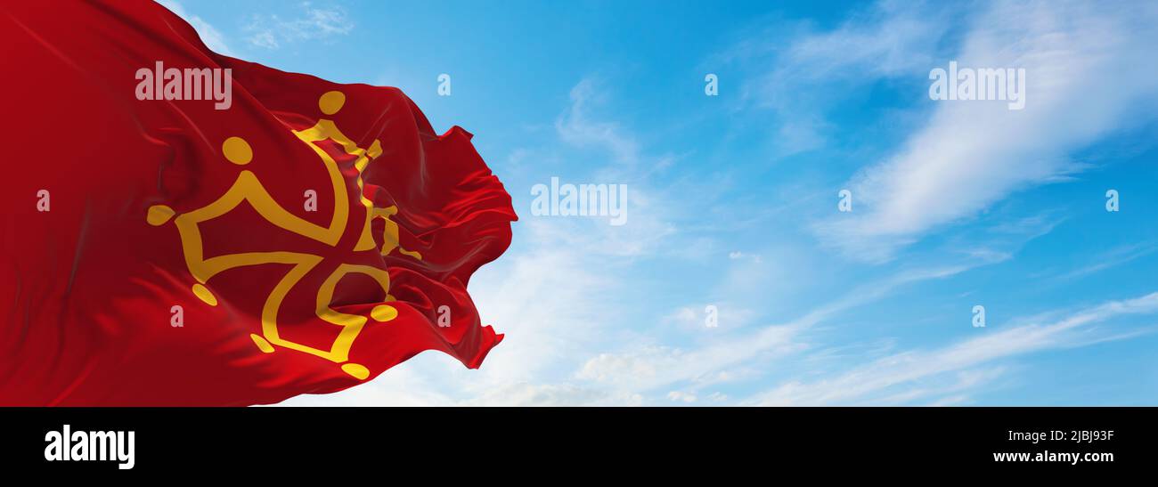 flag of Midi Pyrenees, France at cloudy sky background on sunset ...